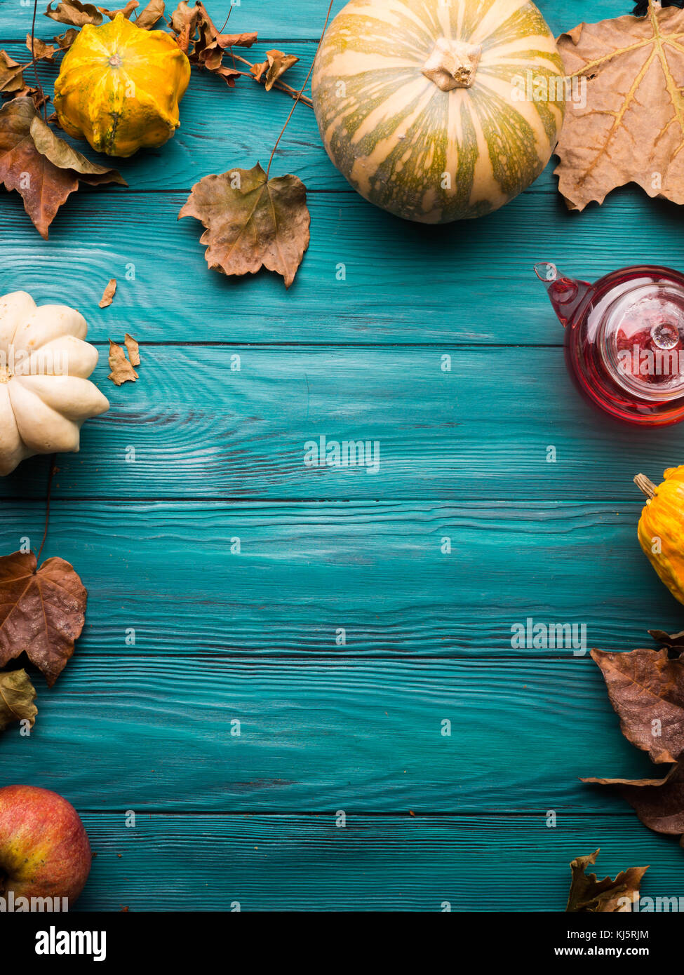 Moody green autumn background with pumpkin, apples, yellow leaves. Fall ...