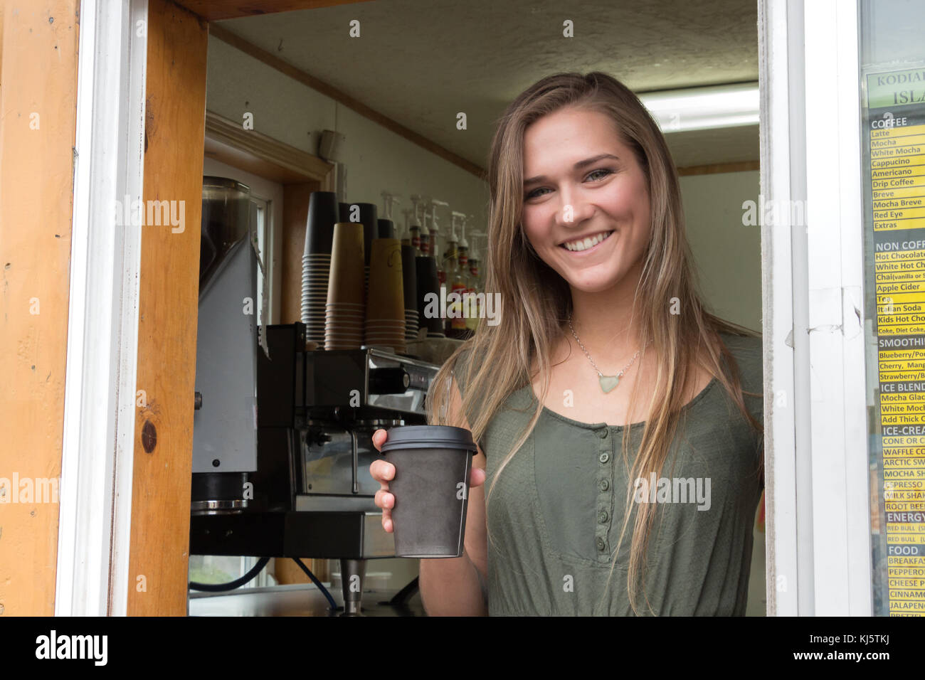Kodiak, Alaska, USA - August 8th, 2017: A female barista is holding a ...