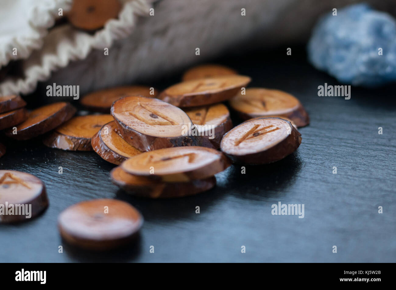 wood runes handmade fur are lying beside the crystal ball and semi ...