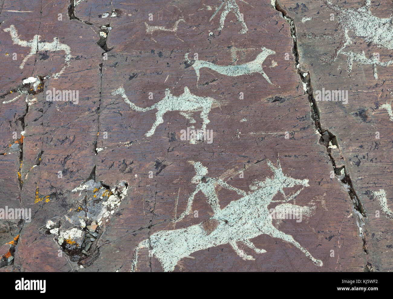 The ancient drawings on rocks Stock Photo - Alamy