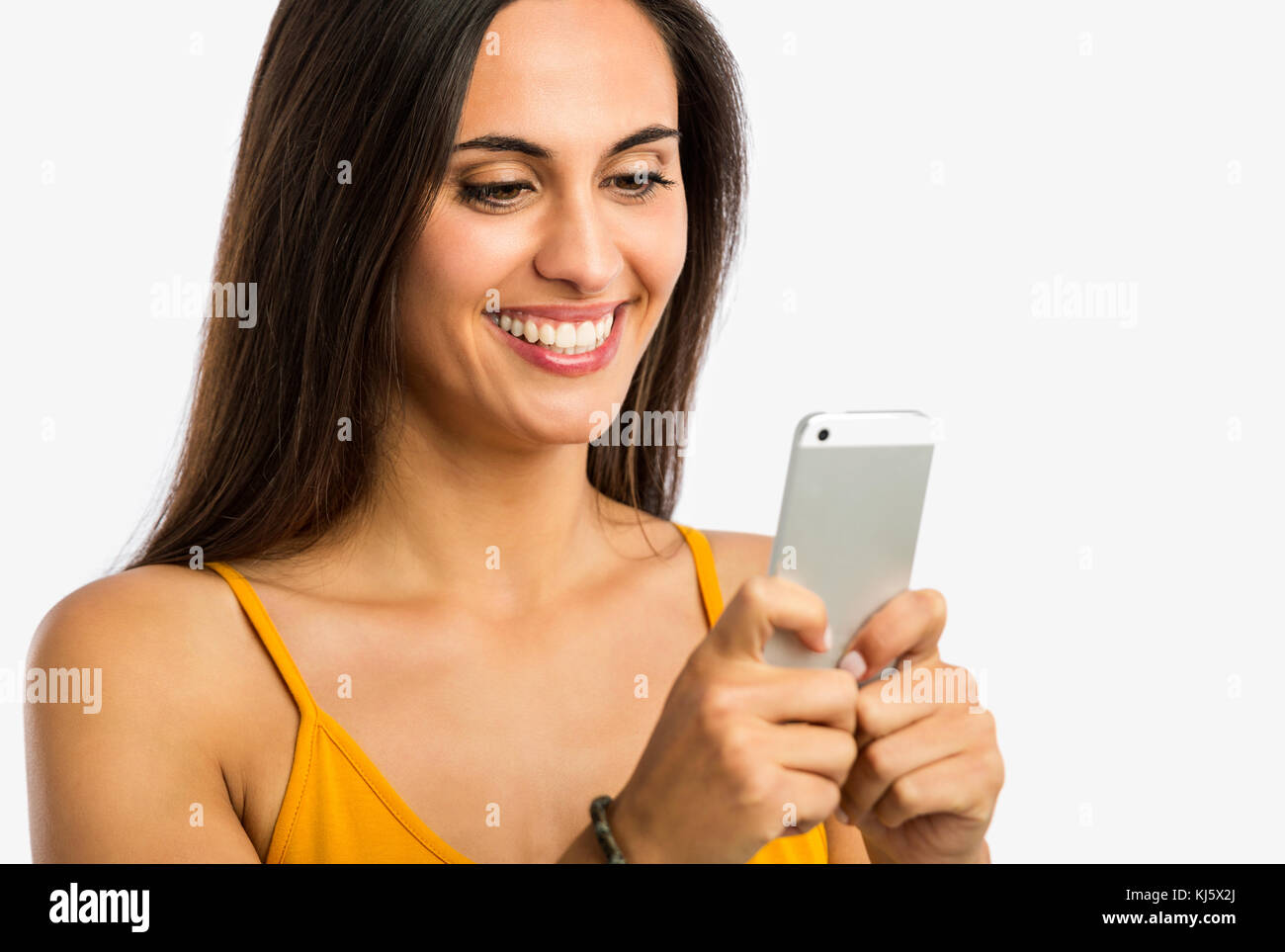 Beautiful and happy young woman sending a text message Stock Photo - Alamy