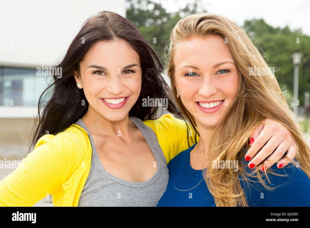 Two beautiful and happy teenage students smiling Stock Photo - Alamy