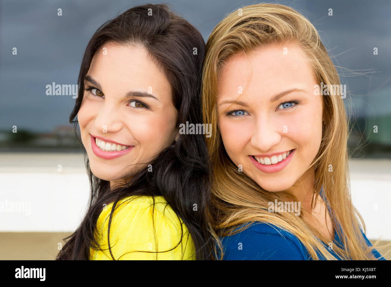 Portrait of a beautiful two young girls smiling Stock Photo - Alamy