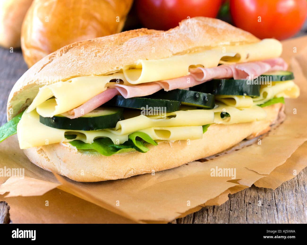 Delicious sandwich stuffed with ham,cheese and salad Stock Photo - Alamy