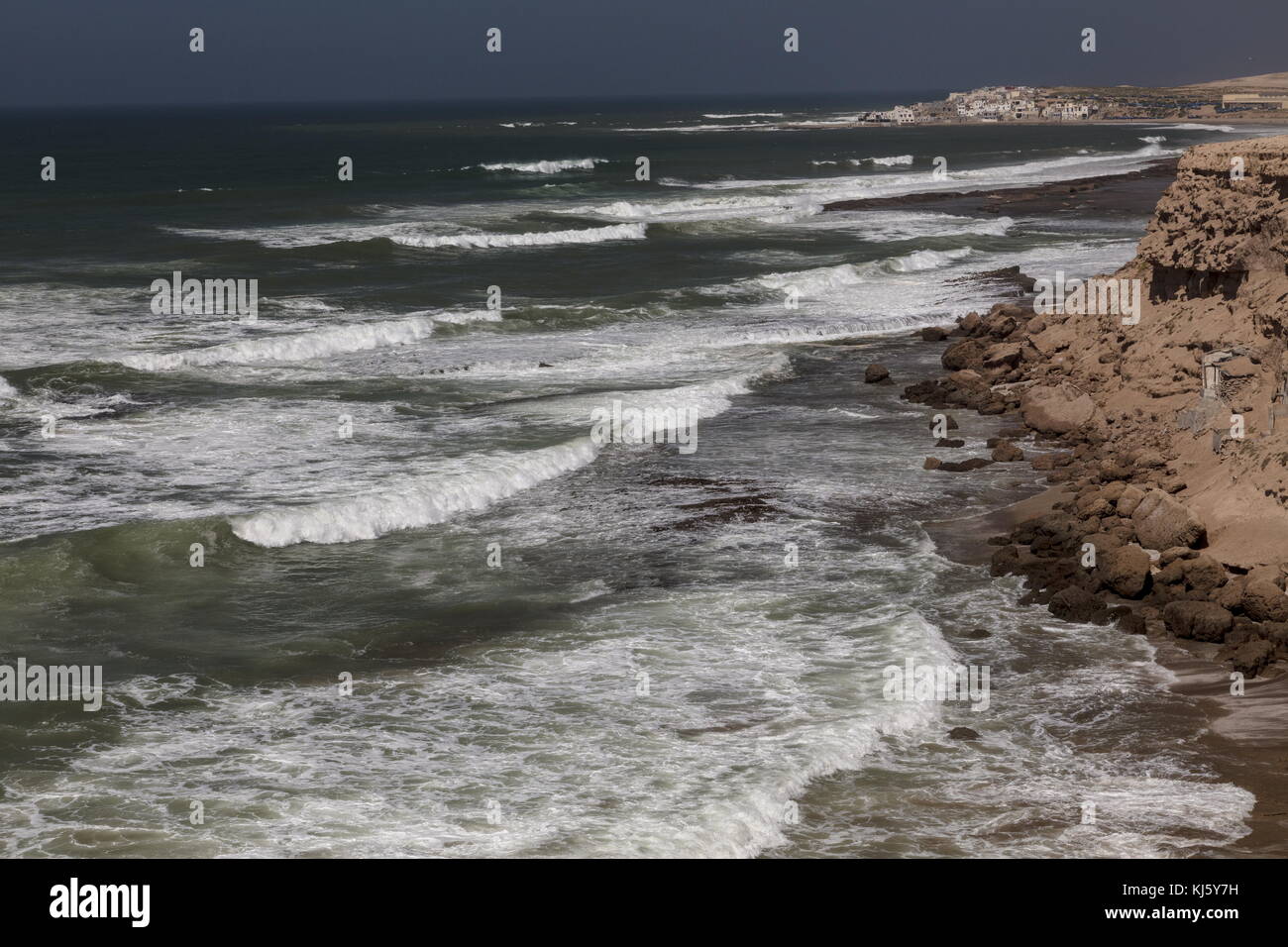 Cliffs and waves, near the village of Tifnit, and Tifnit beach, in the ...
