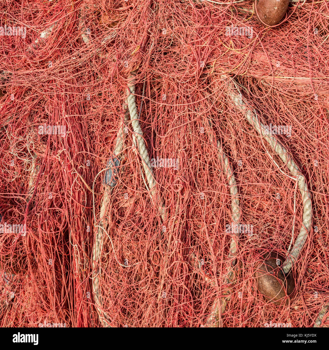 Pile of fishing nets on a quay Stock Photo - Alamy