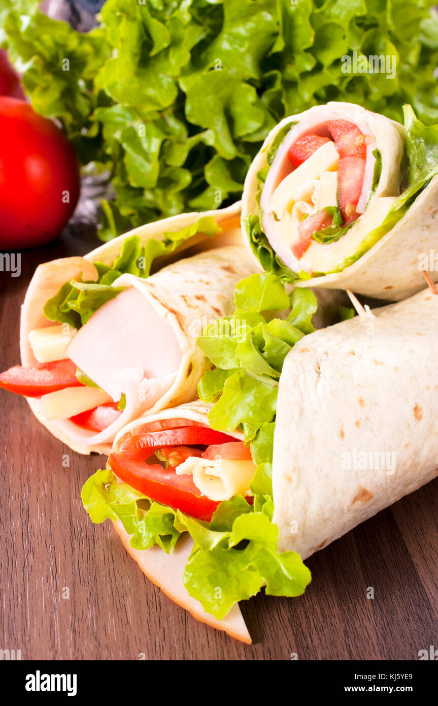 Fresh tortilla wrap sandwiches with vegetables and turkey Stock Photo ...
