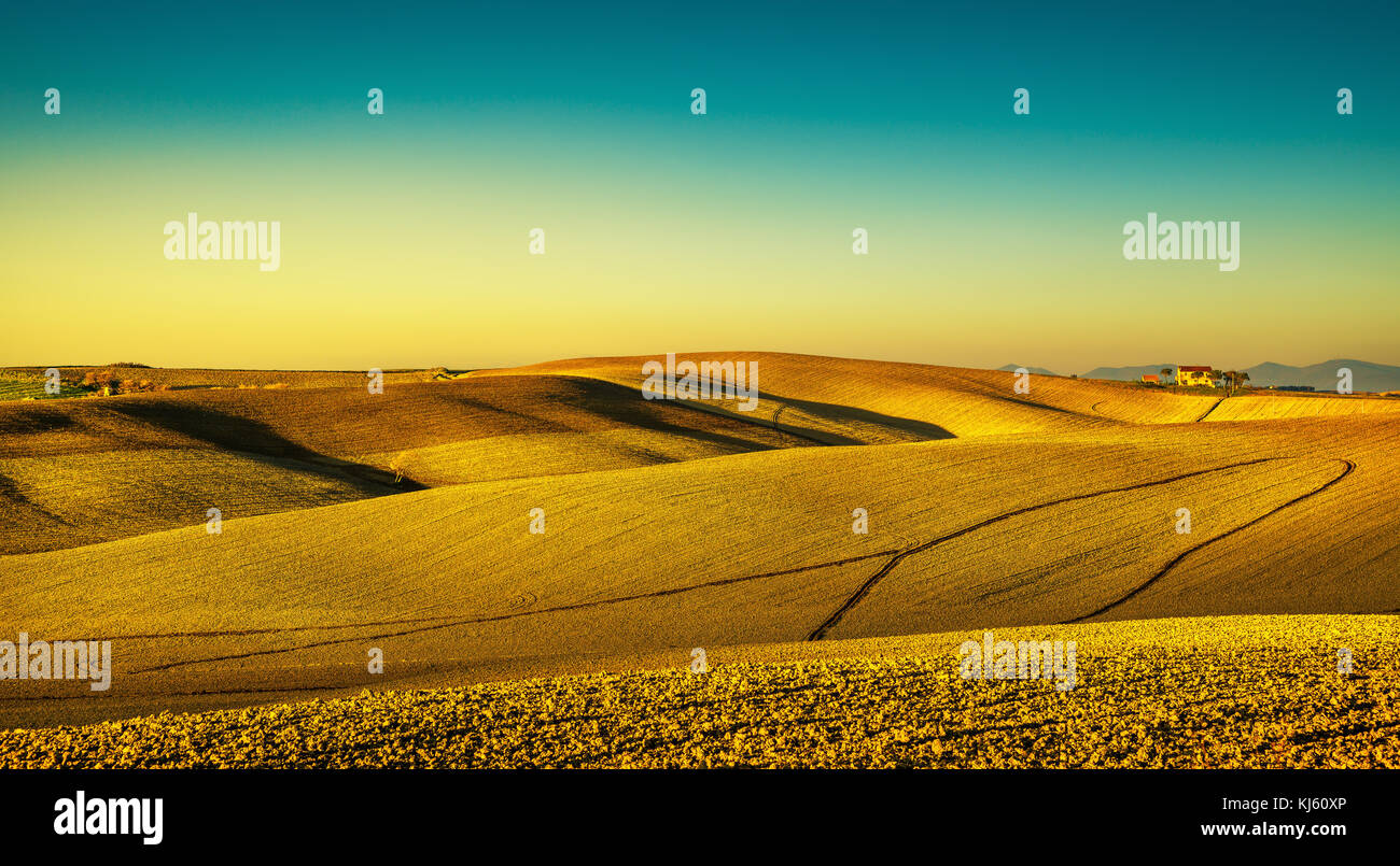 Tuscany countryside panorama, rolling hills and plowed fields on sunset ...