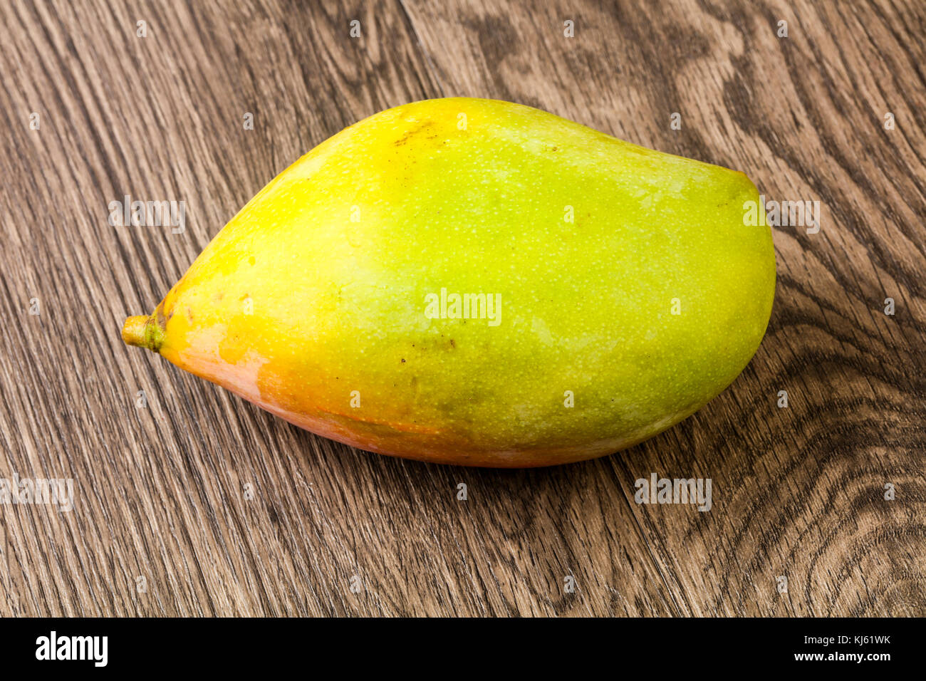 Sweet mango fruit over the wooden background Stock Photo - Alamy