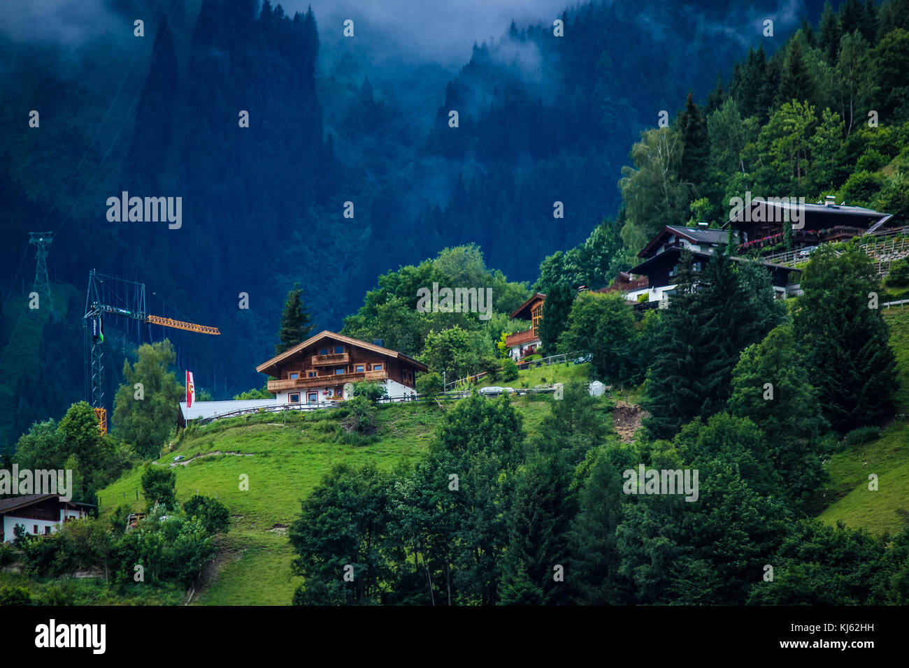 Alpine homes on the mountainside of Zell am See Lake, Austria, Europe on a rainy day Stock Photo ...