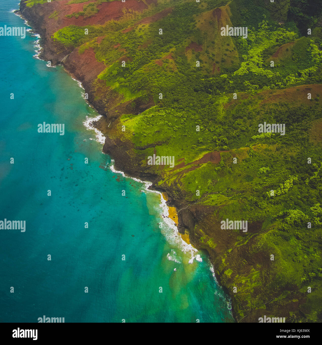 Spectacular aerial of Nā Pali Coast on a cloudy day with green towering ...