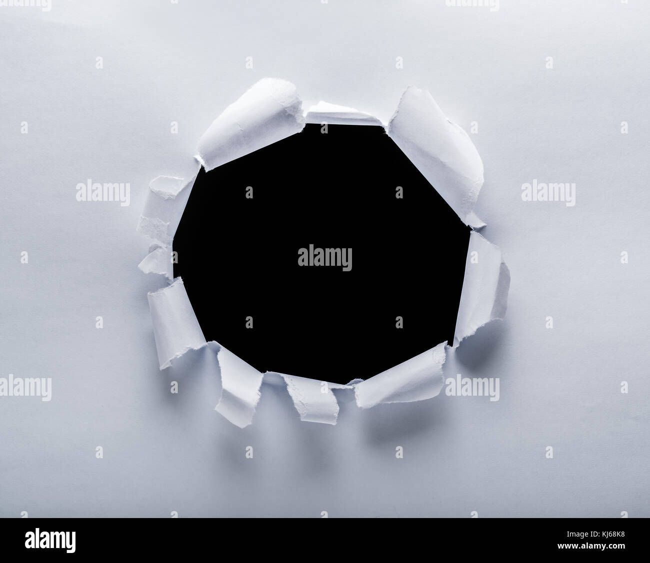 Hole on a paper. Black background in the hole Stock Photo - Alamy