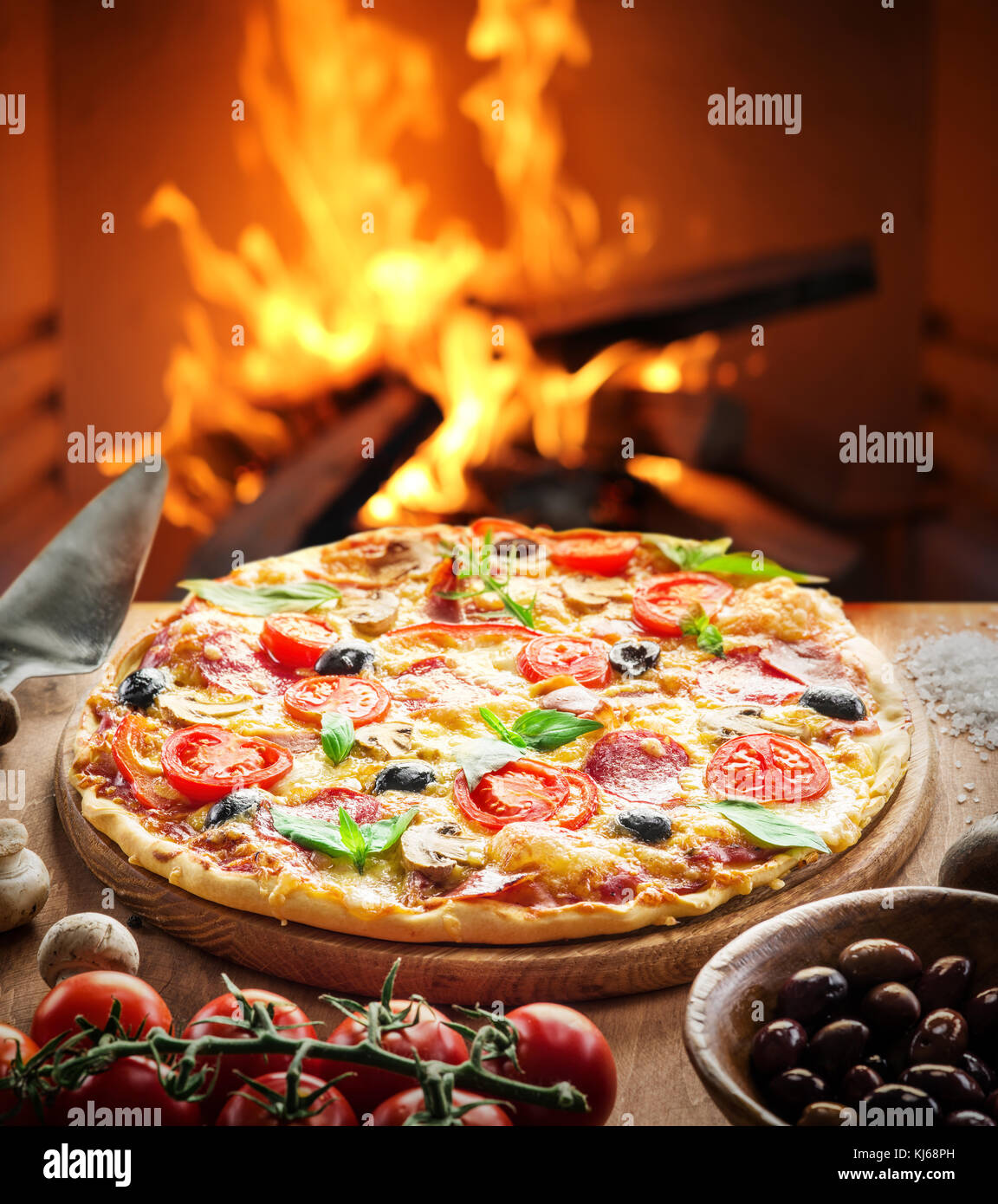 Pizza. Wood-fired oven on the background Stock Photo - Alamy