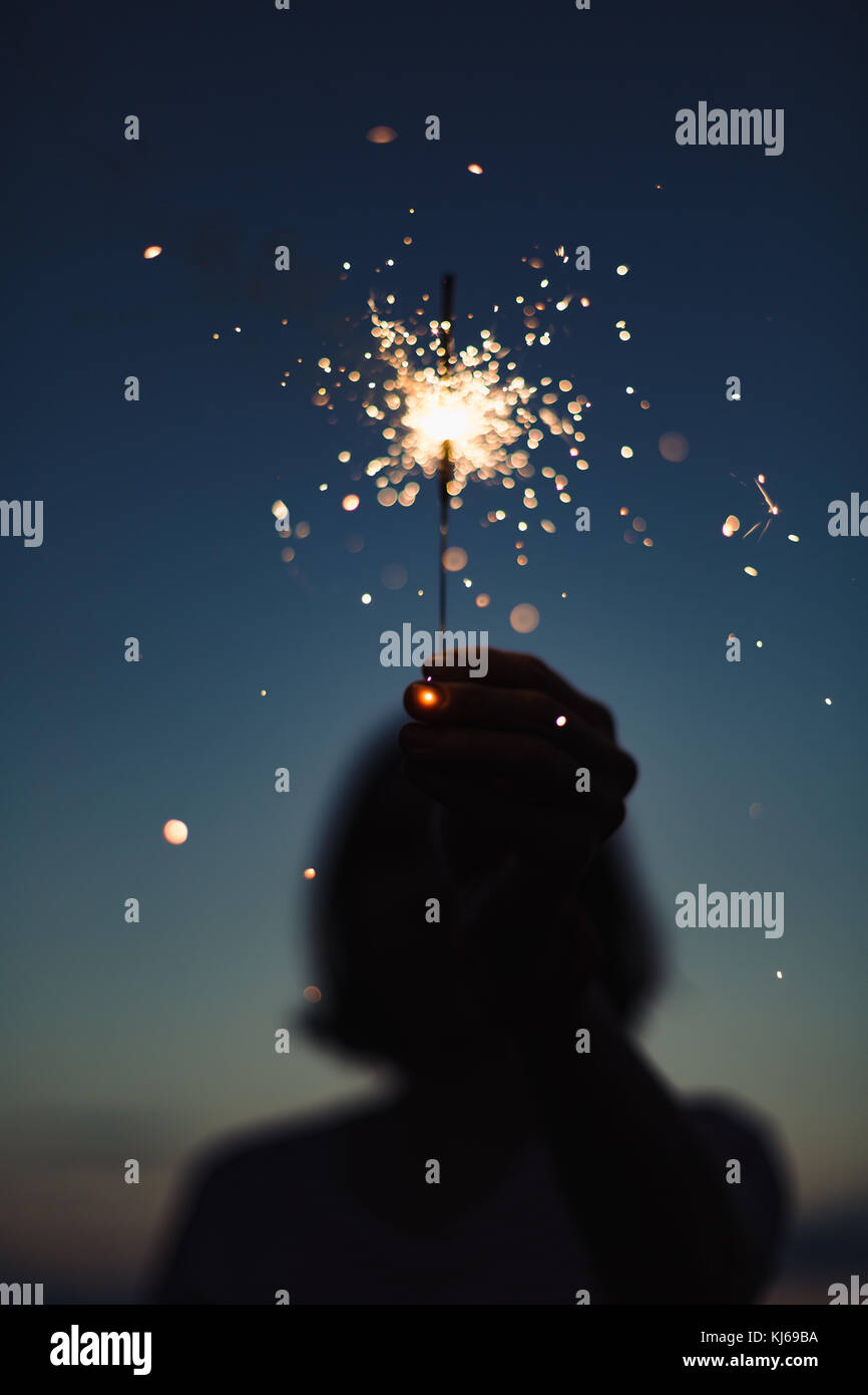 Anonymous person with burning firework Stock Photo - Alamy
