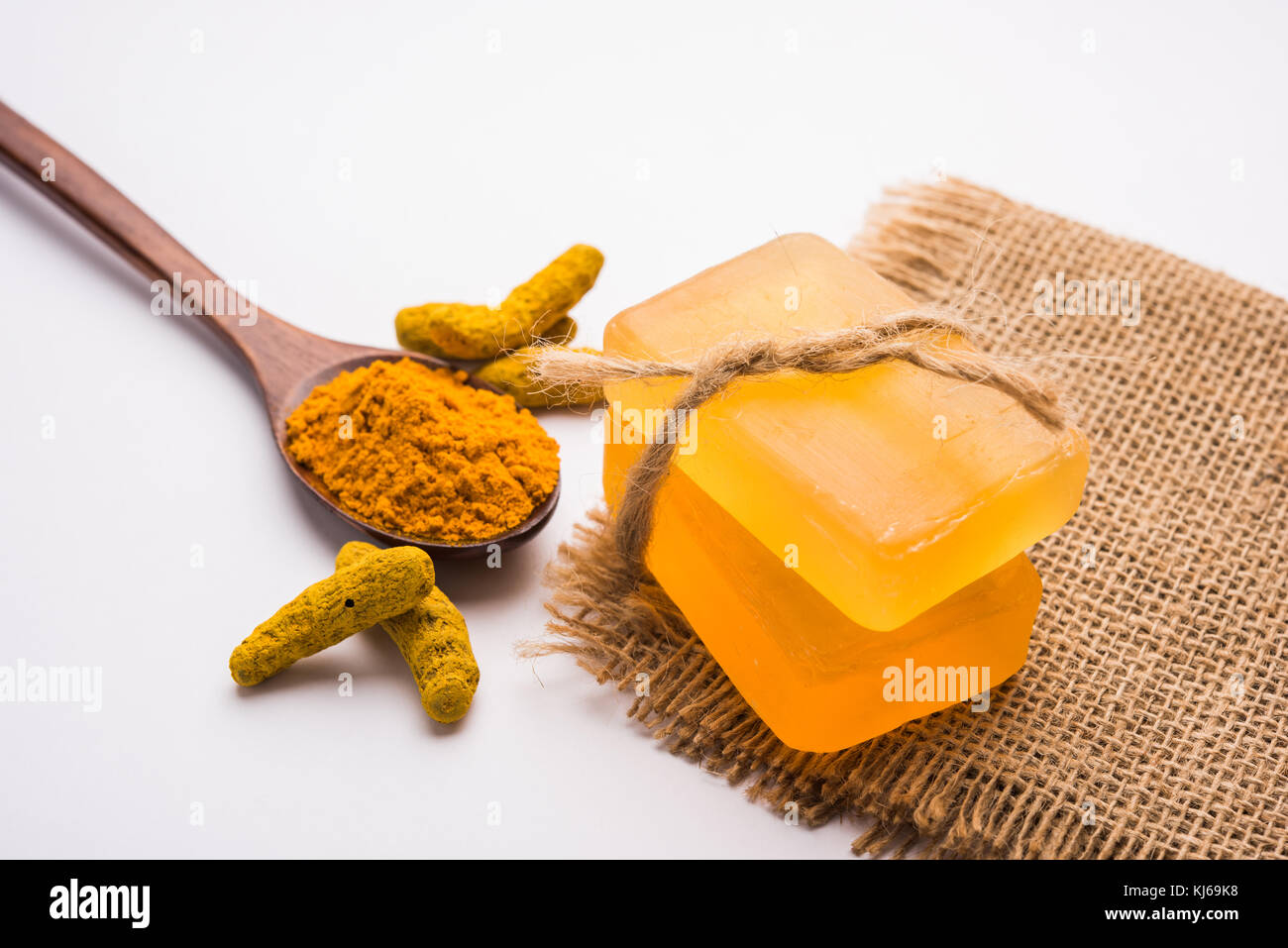 Turmeric essential oil with soap and dried Haldi sticks and powder in a ...