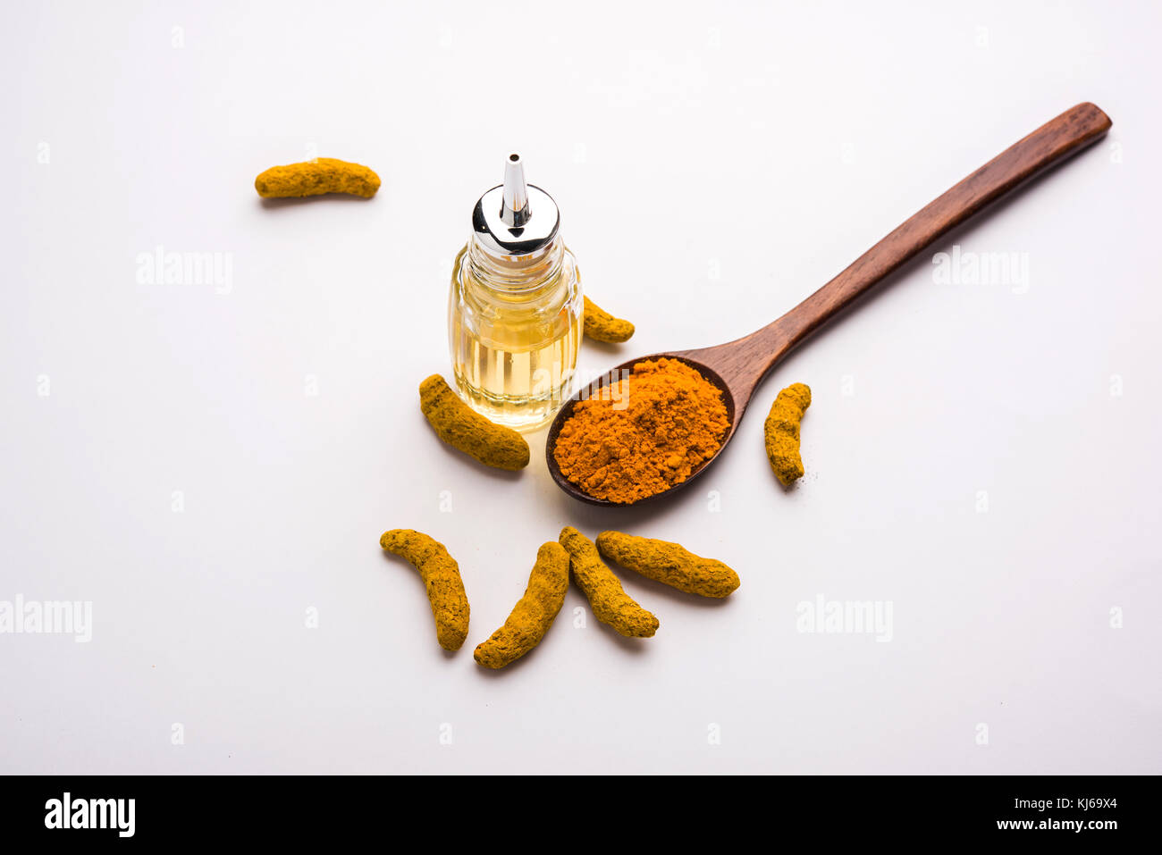 Turmeric essential oil with soap and dried Haldi sticks and powder in a ...