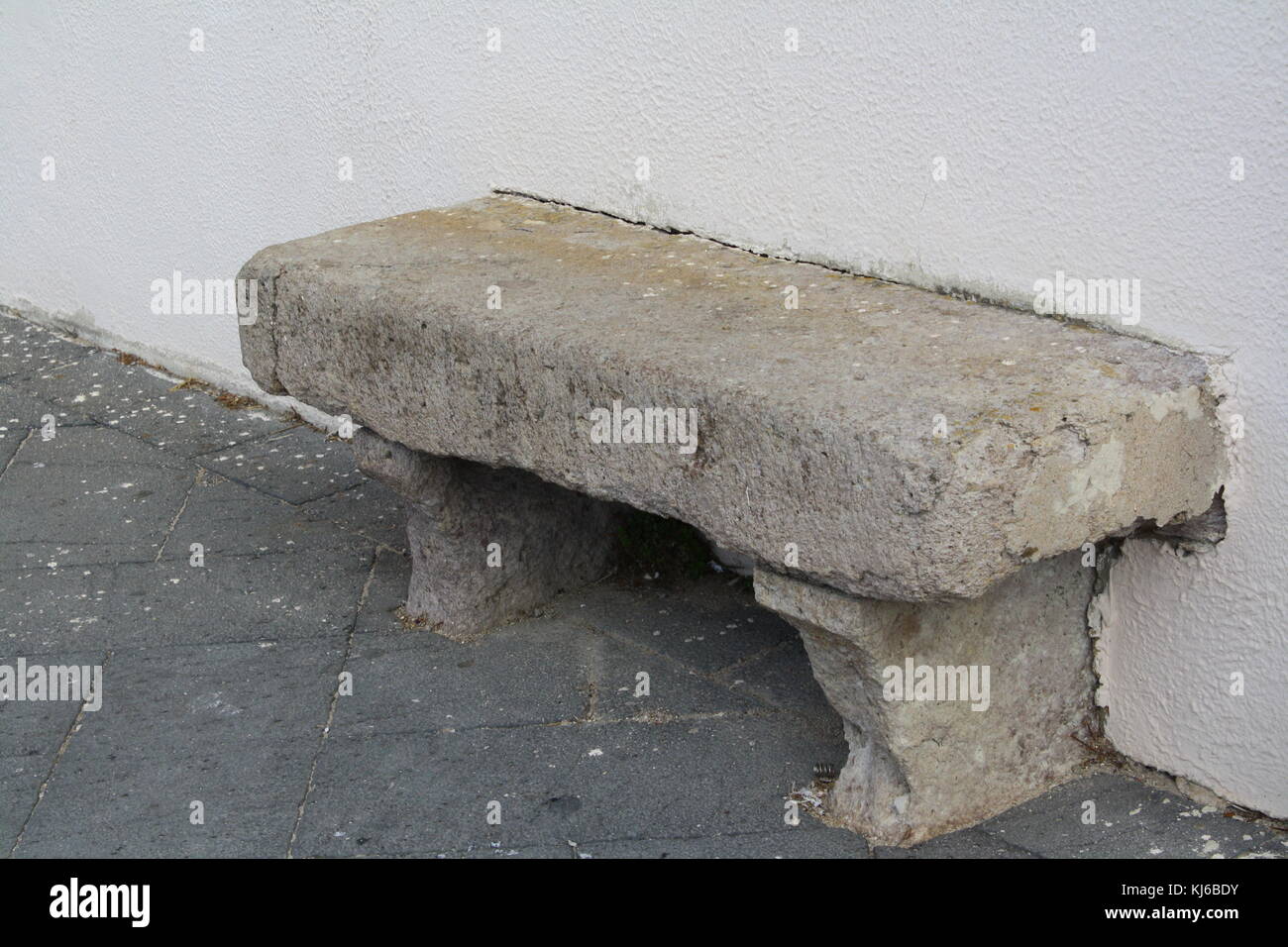 An old stone bench in the side of a building Stock Photo - Alamy