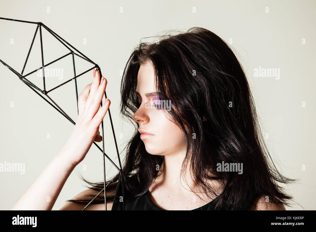 Female holding model of geometric solid Stock Photo - Alamy