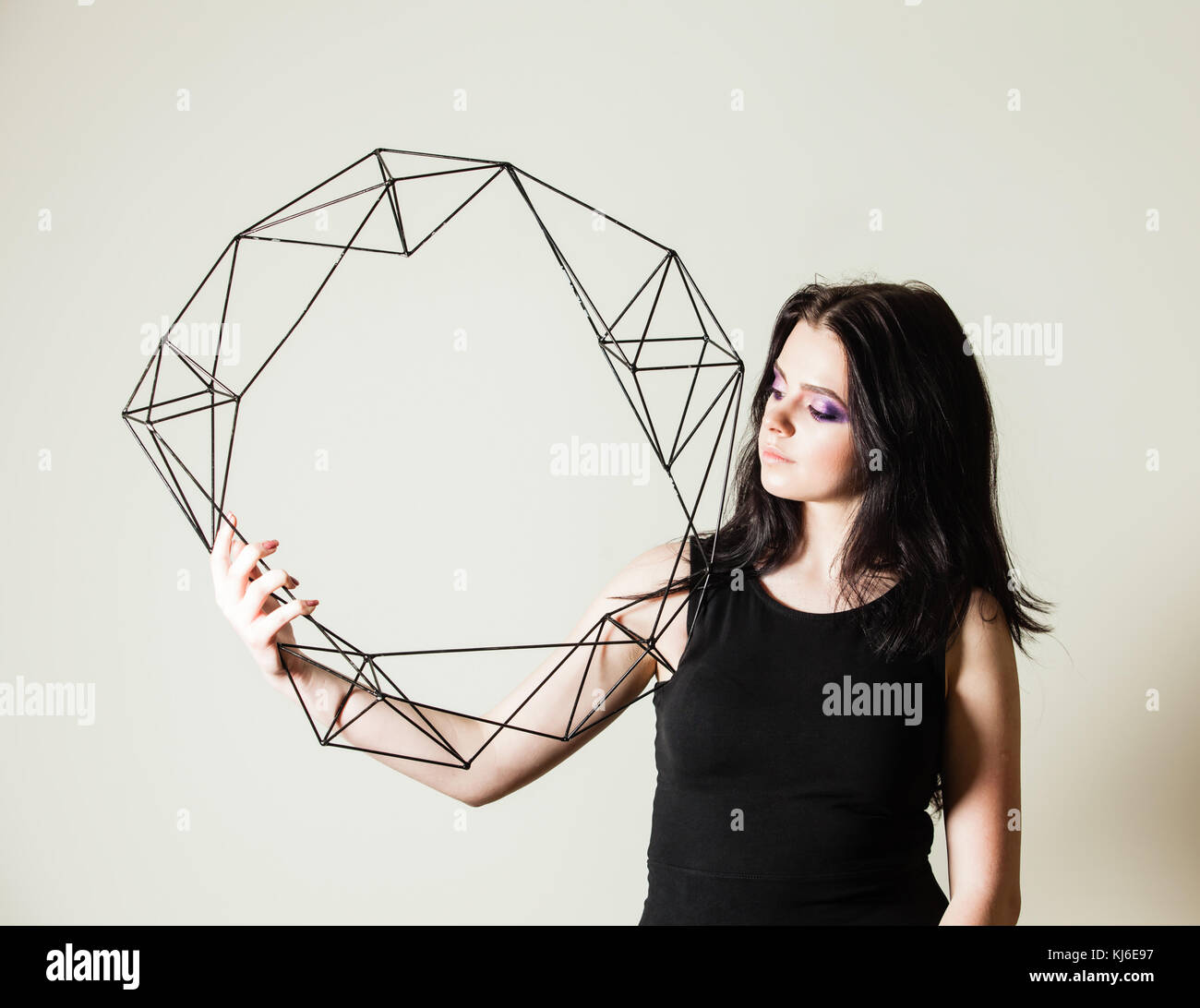 Female holding model of geometric solid Stock Photo - Alamy