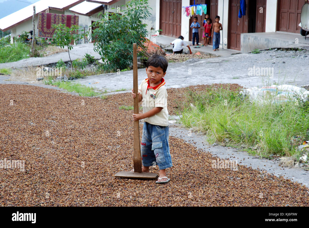 Little returnee boy helping out. Photo taken in Aceh, Indonesia, in ...