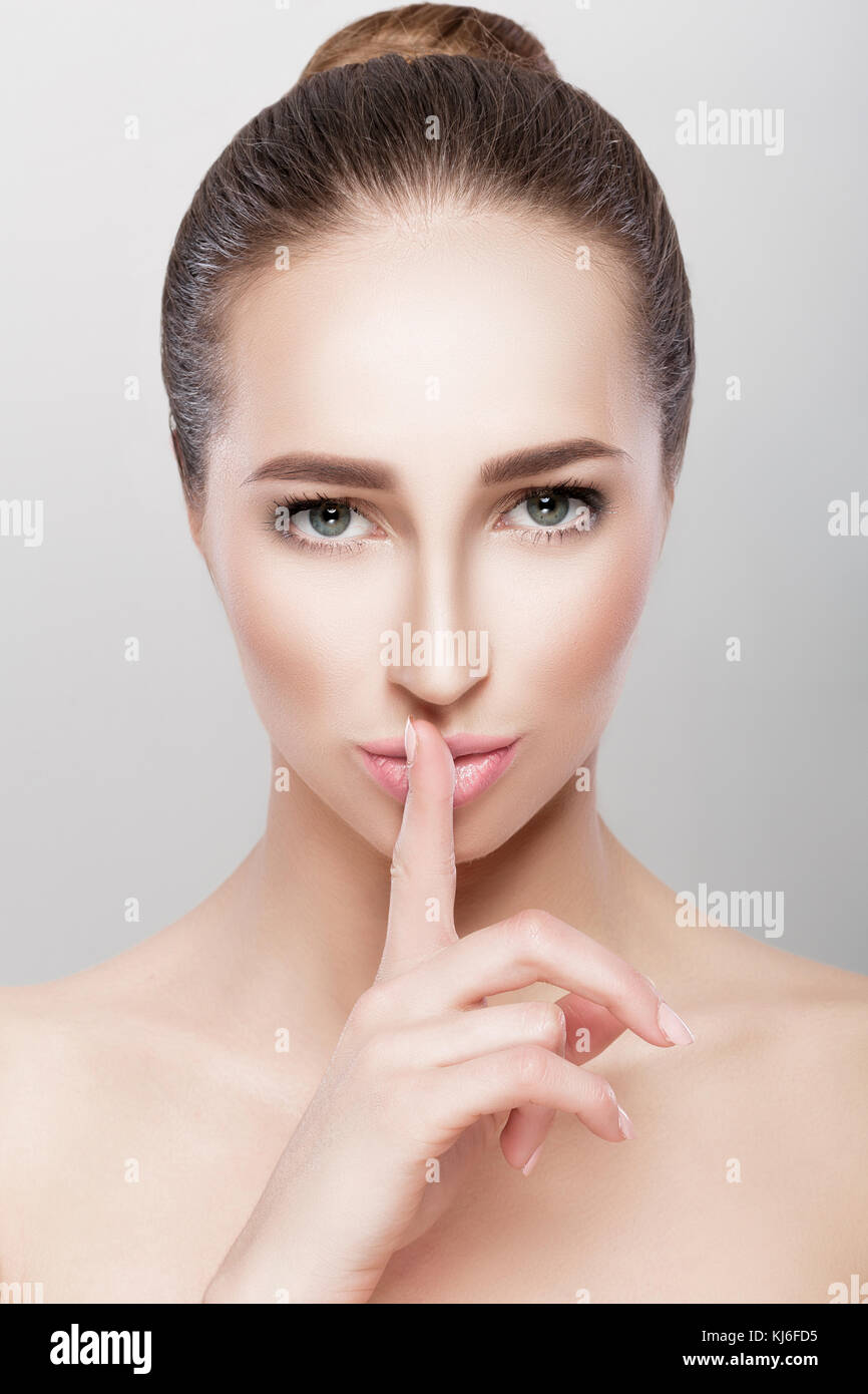 woman showing silence gesture Stock Photo - Alamy