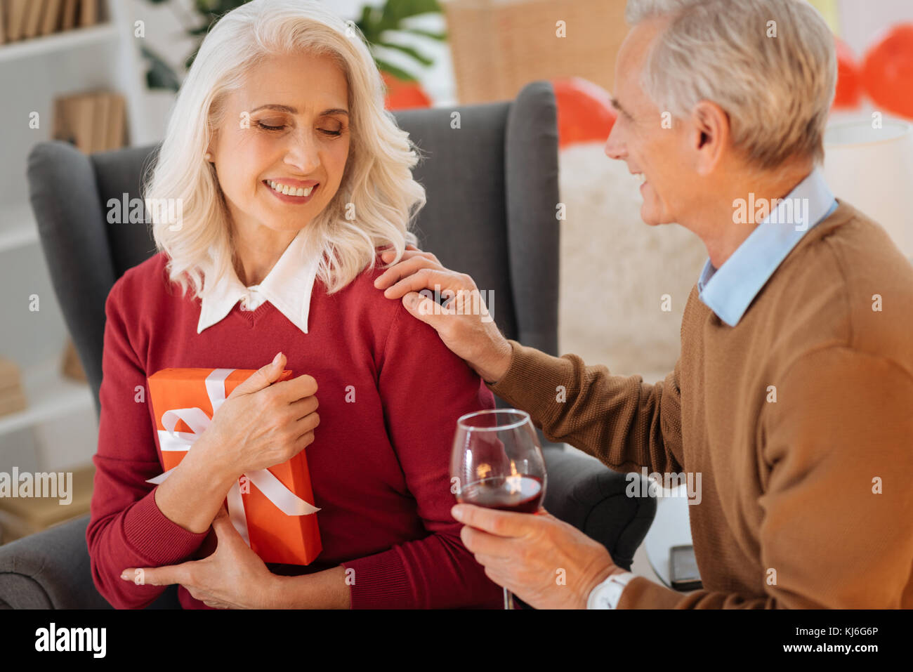 Thoughtful gentleman surprising his with with present Stock Photo - Alamy