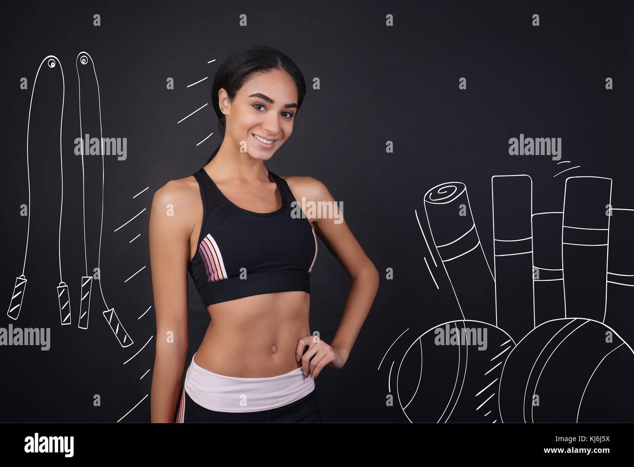 Cheerful smiling woman exercising in a gym Stock Photo - Alamy