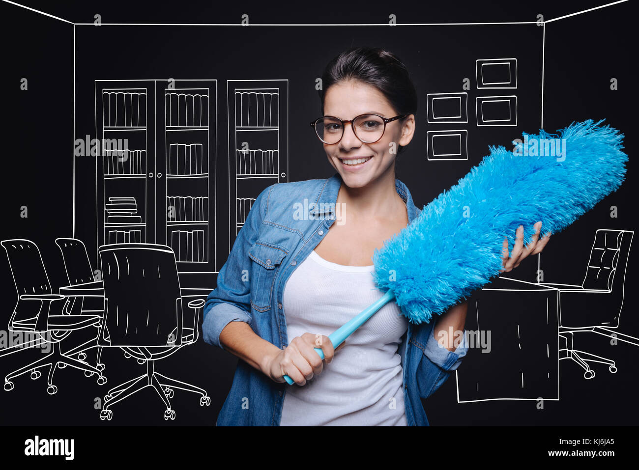 Joyful woman cleaning dust Stock Photo - Alamy