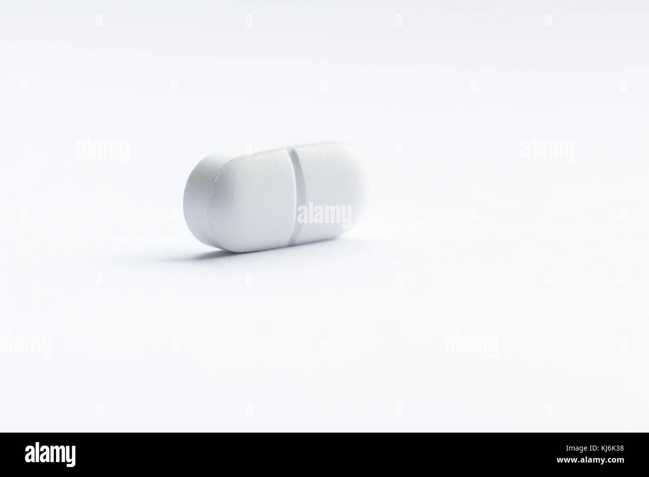 close up of a group of white tablets isolated on a white background ...