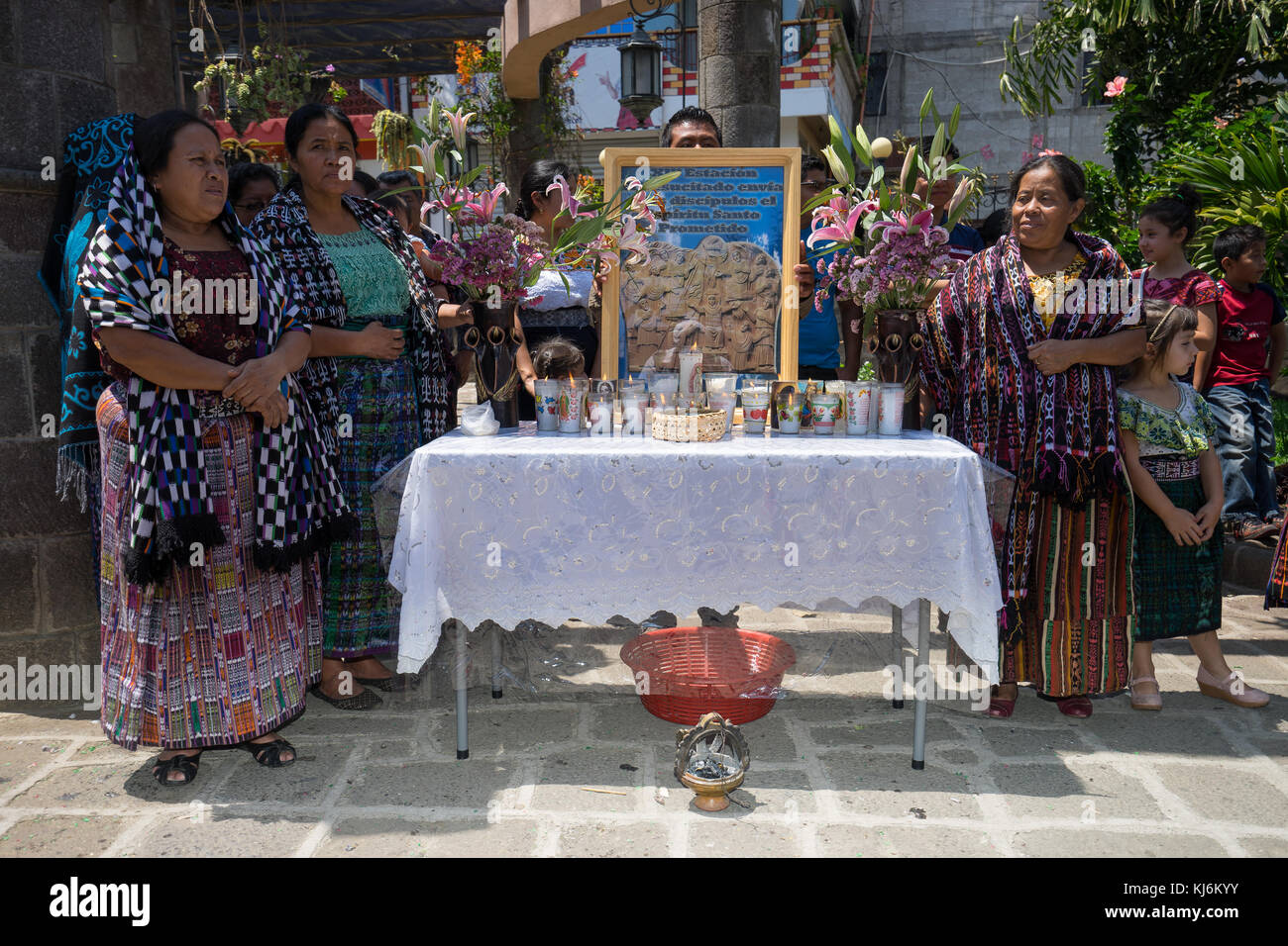 tzutujil maya women in traditional clothes standing by a praying ...