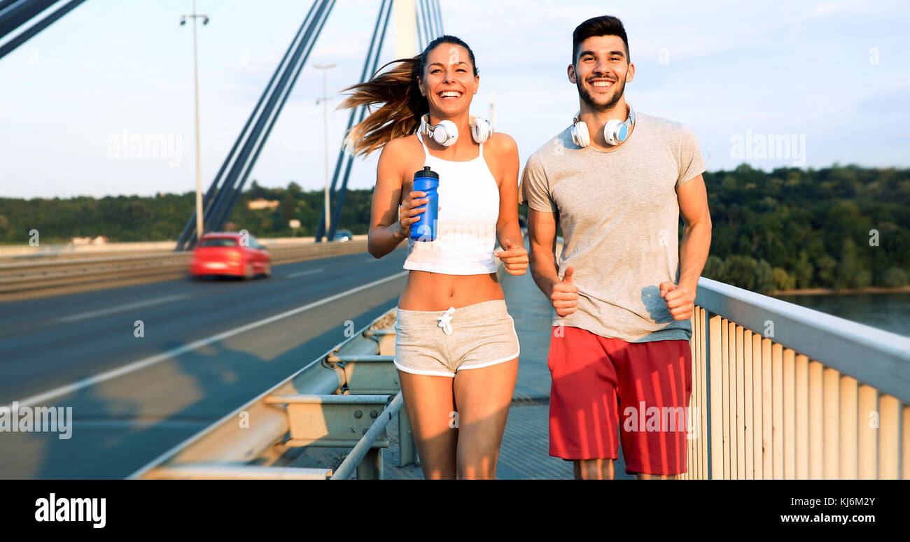Couple jogging outdoors Stock Photo - Alamy