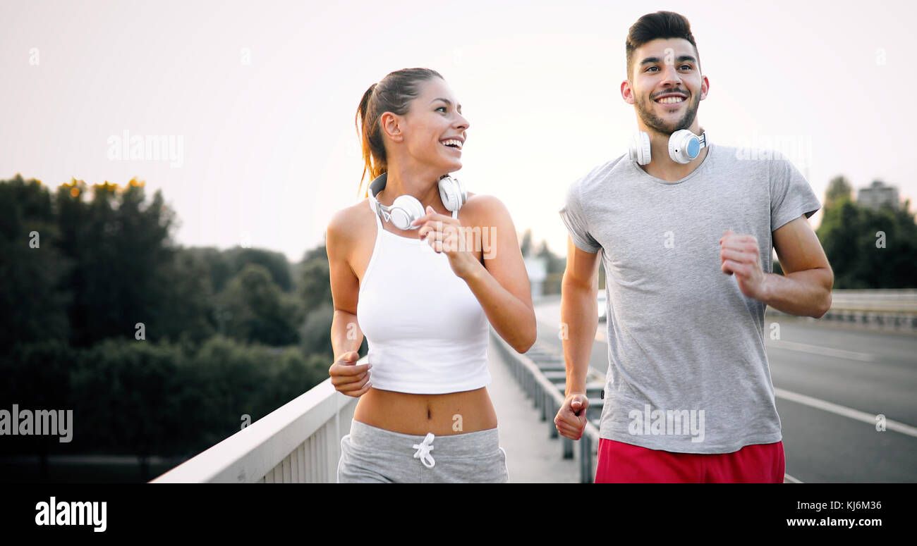 City running couple jogging outside Stock Photo - Alamy