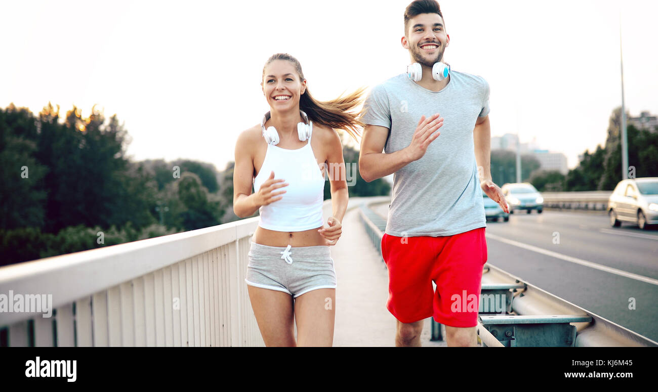 City running couple jogging outside Stock Photo - Alamy
