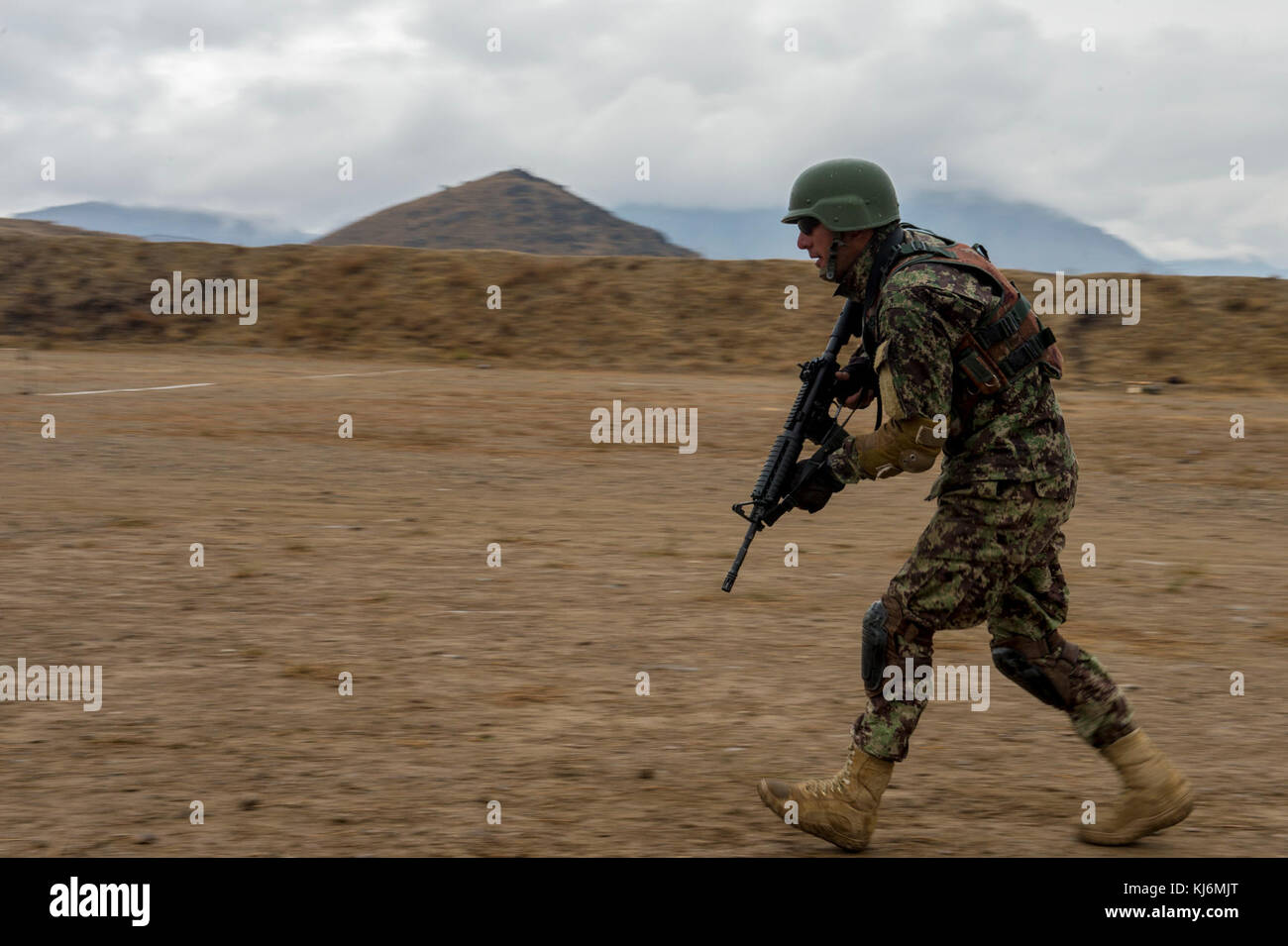 An Afghan Commando trainee moves to a covered position during a team ...