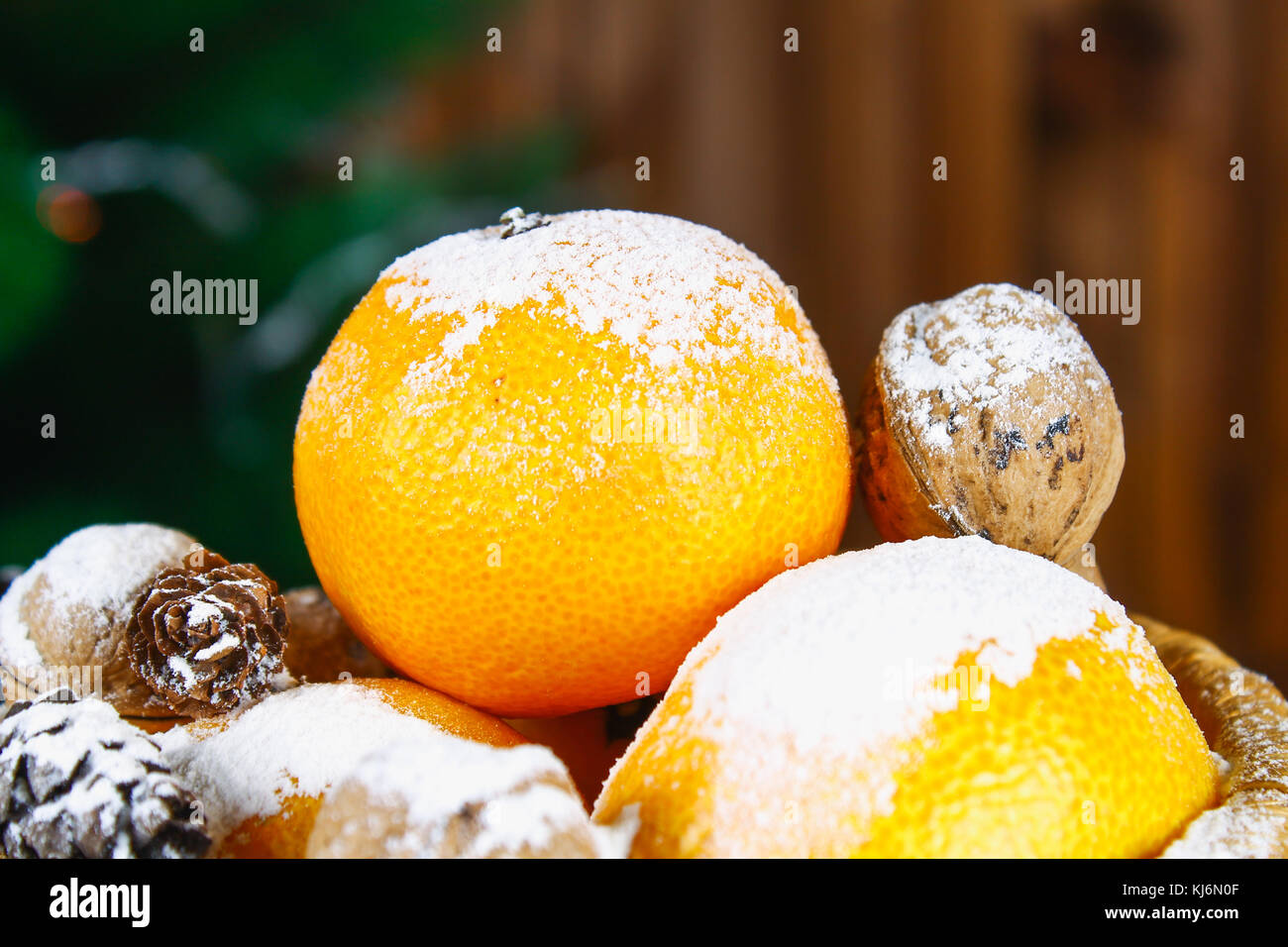 Mandarins, walnuts and bumps in a basket on the background of a ...