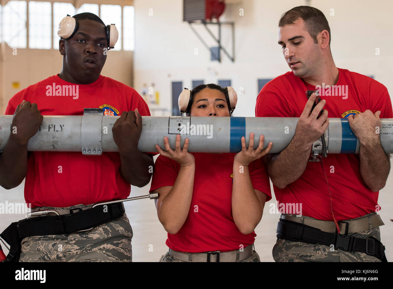 The 75th Aircraft Maintenance Unit (AMU) load crew carries an inert AIM ...