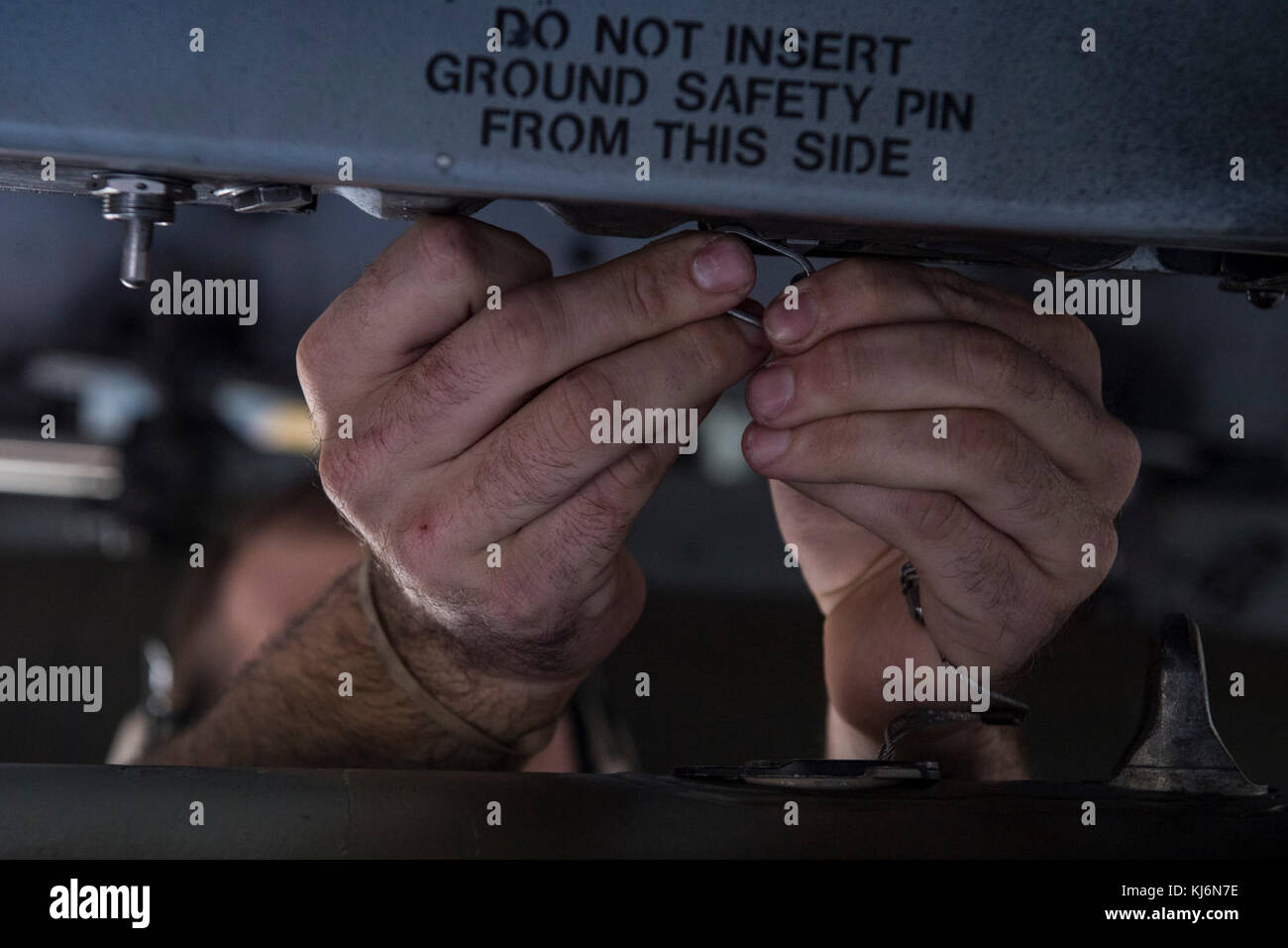 Staff Sgt. Kyle Davey, 75th AMU weapons load crew chief (AMU), installs ...