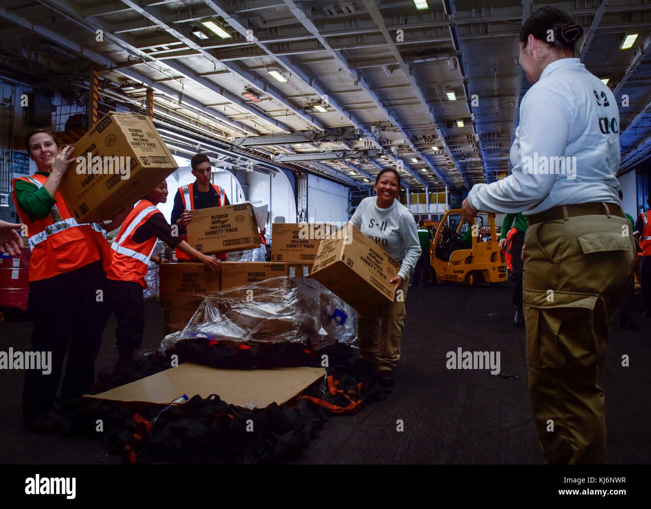 PACIFIC OCEAN (Nov. 18, 2017) U.S. Navy Sailors pass boxes to each ...
