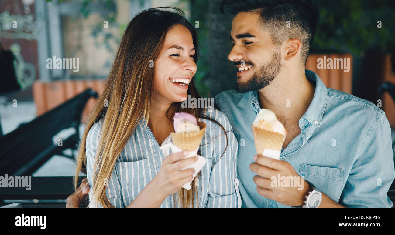 Happy couple having date and eating ice cream Stock Photo - Alamy