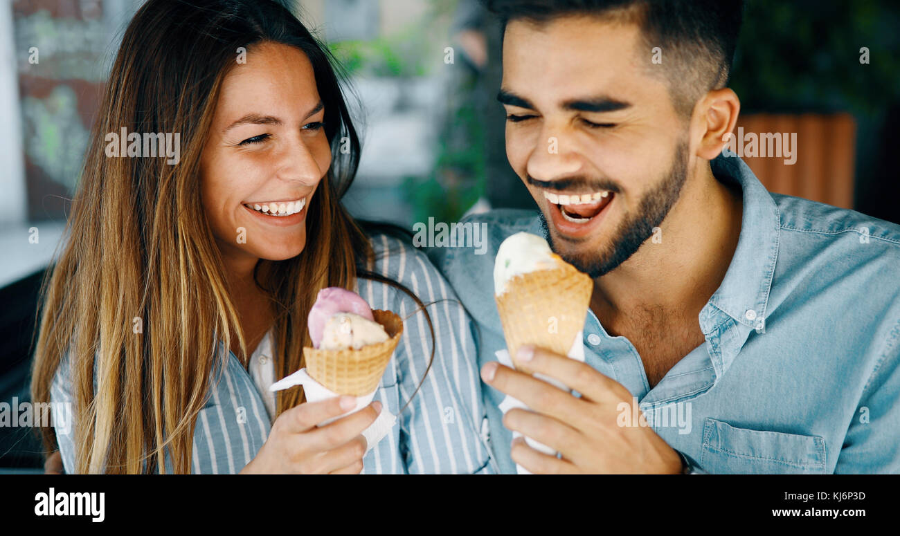 Happy couple having date and eating ice cream Stock Photo - Alamy