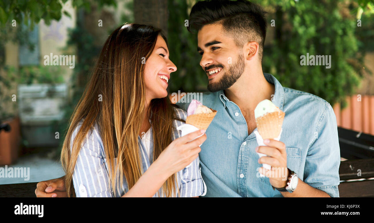 Happy couple having date and eating ice cream Stock Photo - Alamy