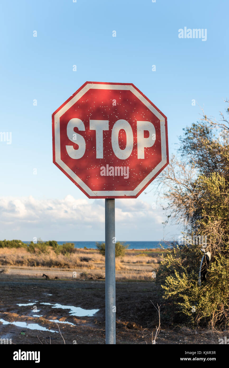 Stop sign on village road near the sea shot by shotgun - Mazotos ...