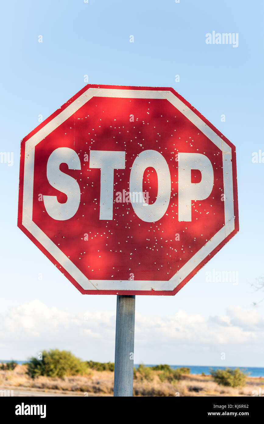 Stop sign on village road near the sea shot by shotgun - Mazotos ...