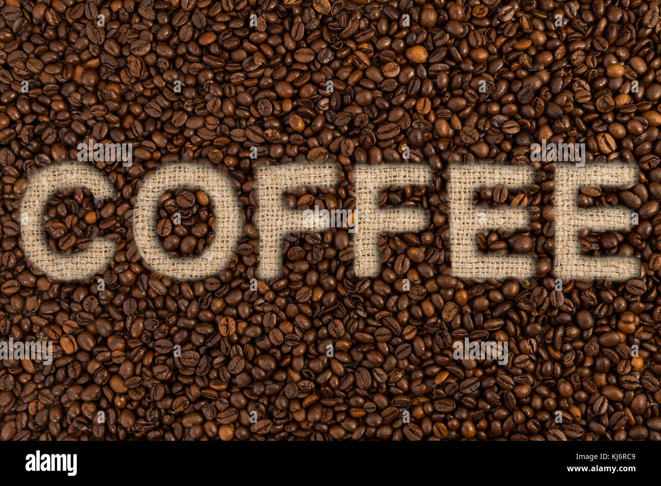 Coffee text on roasted beans and jute bag or sack as written letters ...