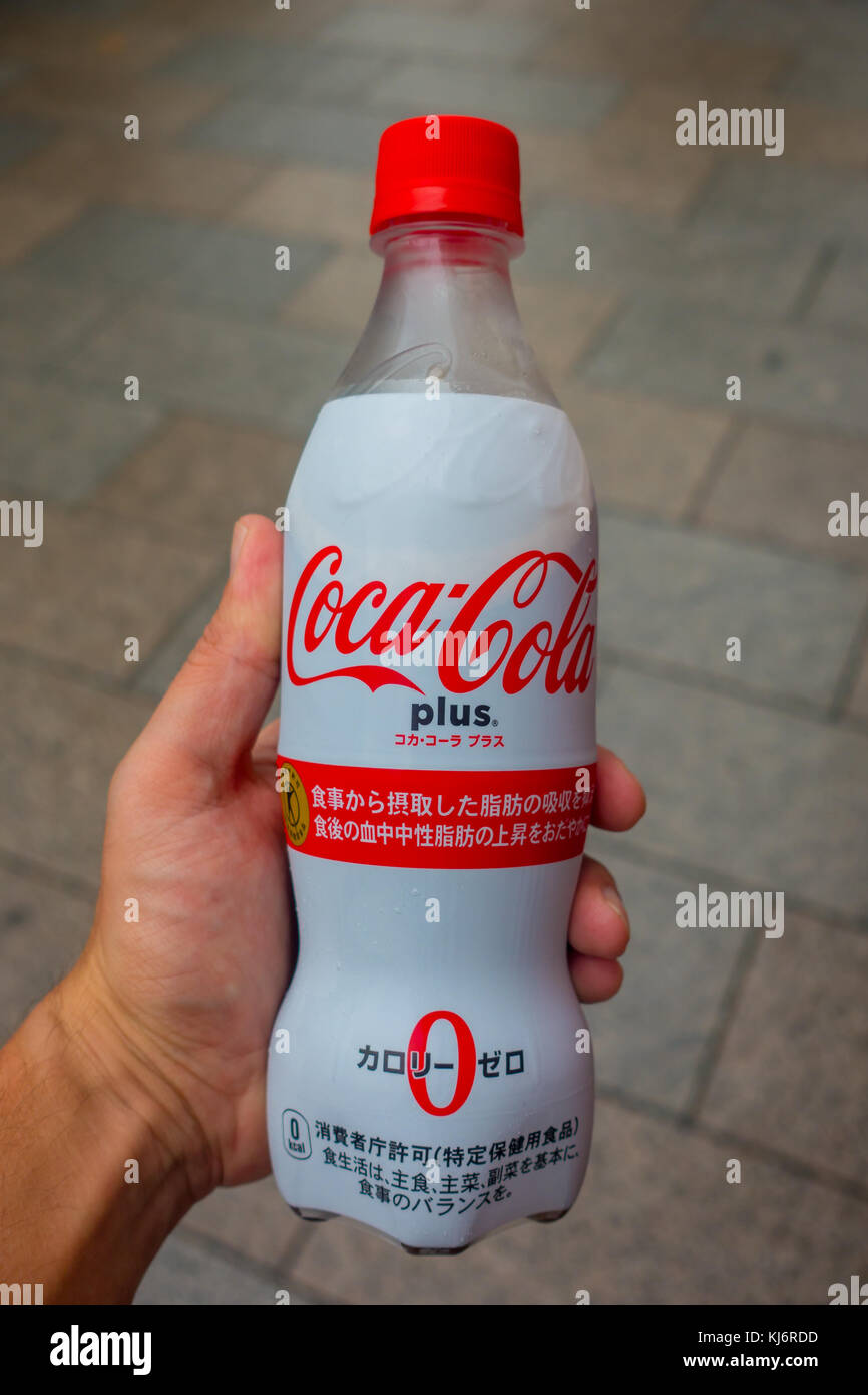 TOKYO, JAPAN -28 JUN 2017: Hand holding the new Coca Cola Plus, now available in some vending ...