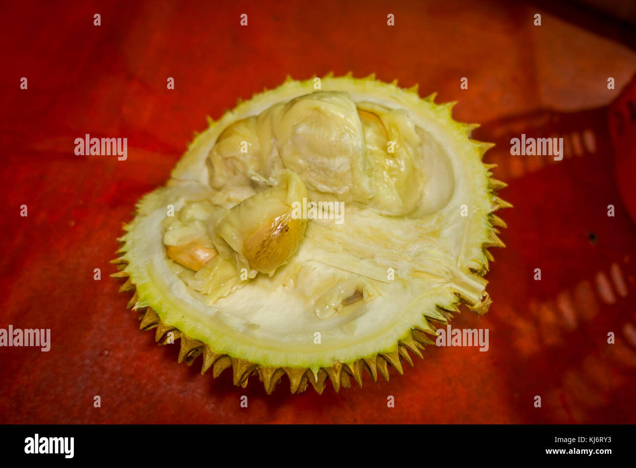 Close up keledang fruit seen from above, red background Stock Photo - Alamy