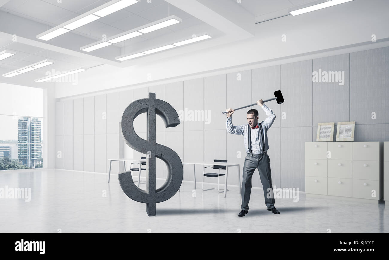 Determined banker man in modern office interior breaking dollar Stock ...