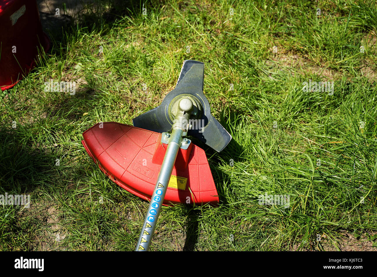 Grass cutter / brush cutter for trimming overgrown grass Stock Photo ...