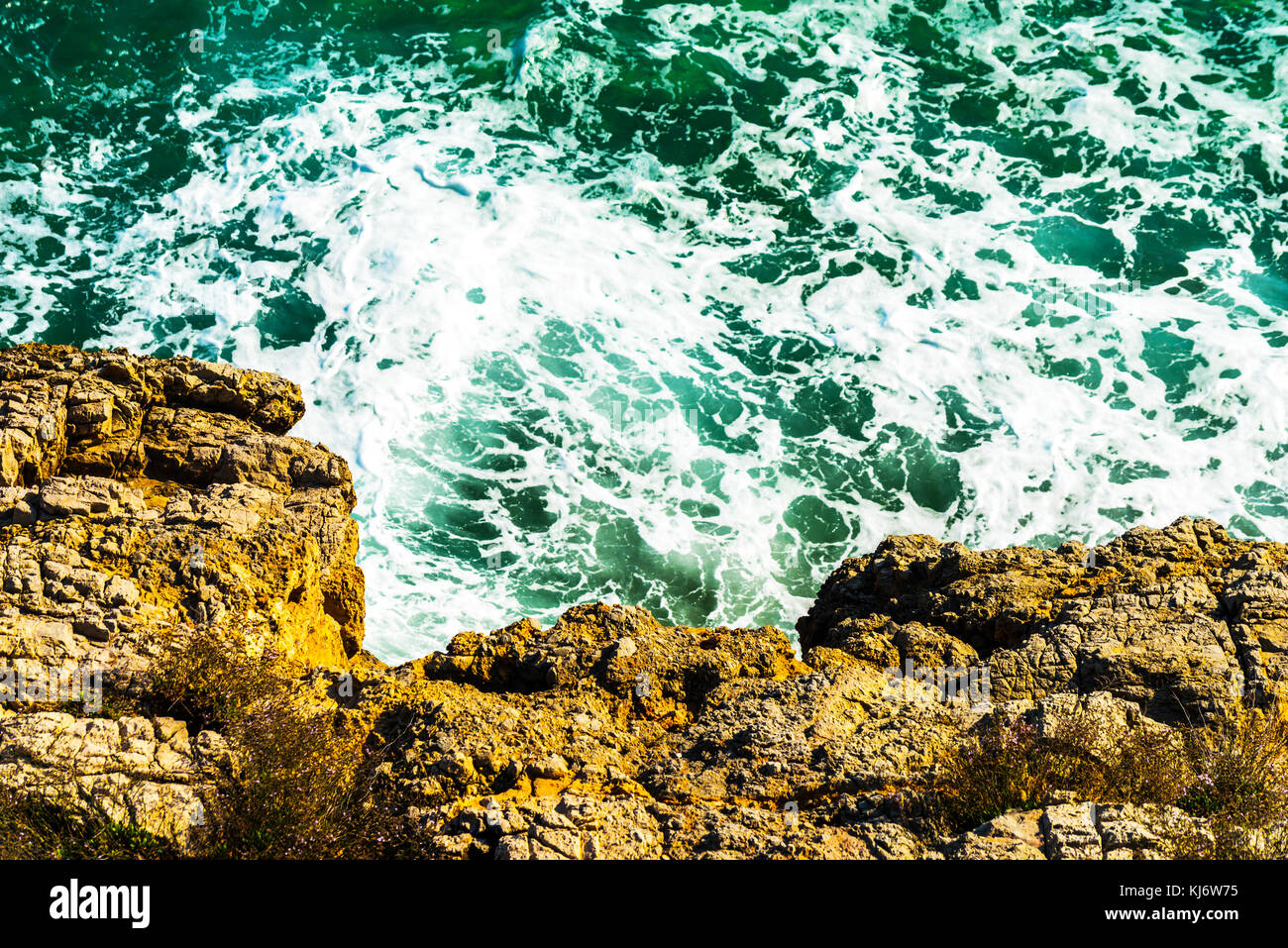 high cliff above the sea, summer sea background, many splashing waves ...