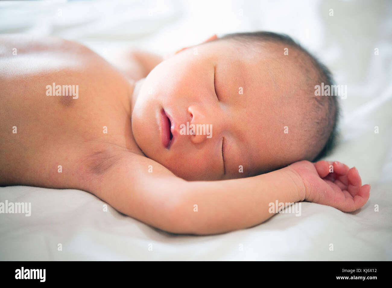 Cute Asian newborn baby sleeping Stock Photo - Alamy